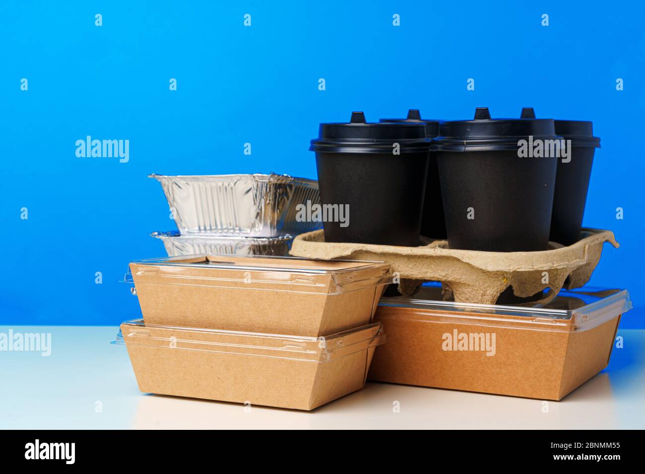 Assortment of various food delivery containers on table Stock Photo - Alamy