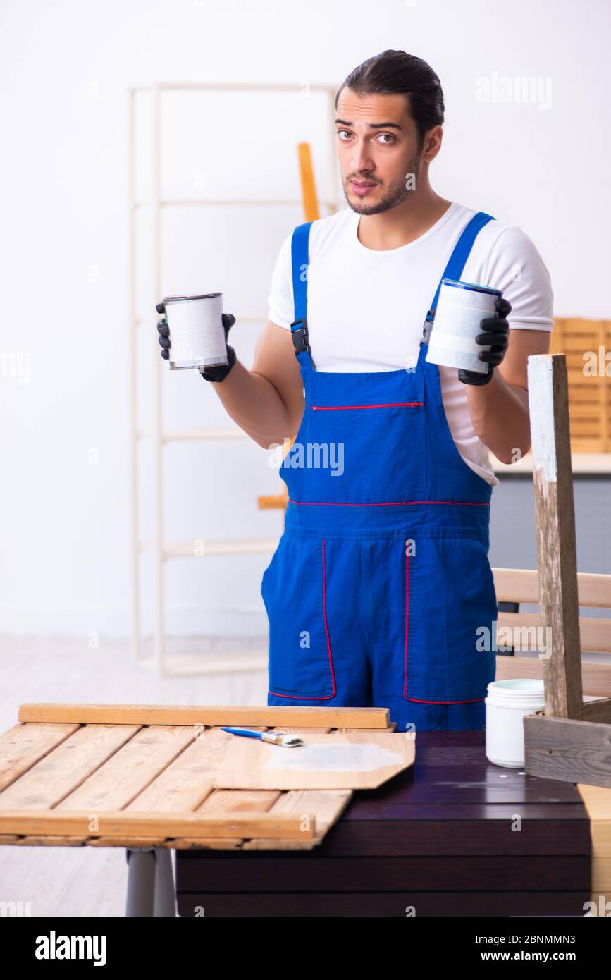 Young male contractor working in the workshop Stock Photo - Alamy