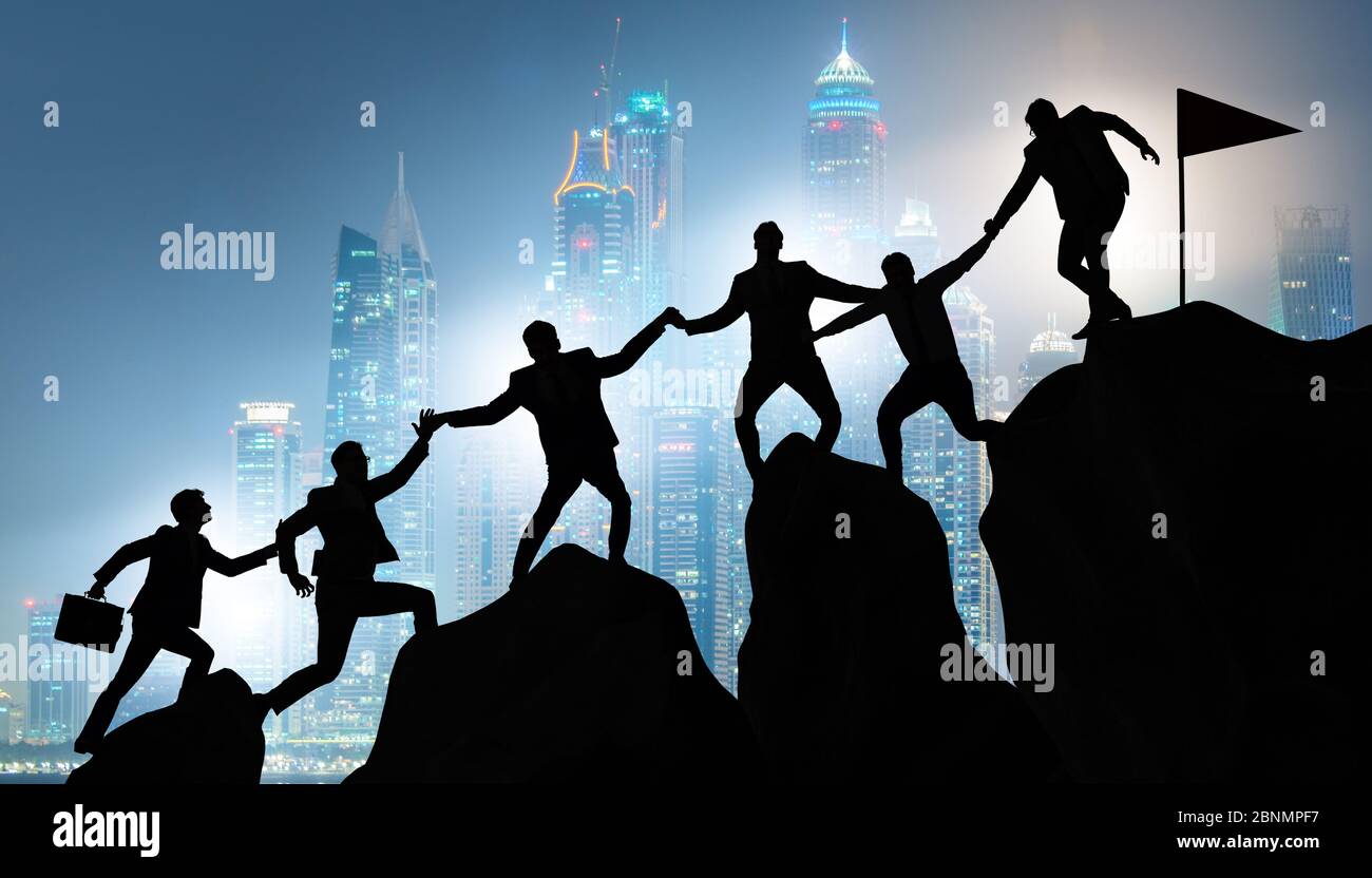 Concept of teamwork with the team climbing mountain top Stock Photo - Alamy