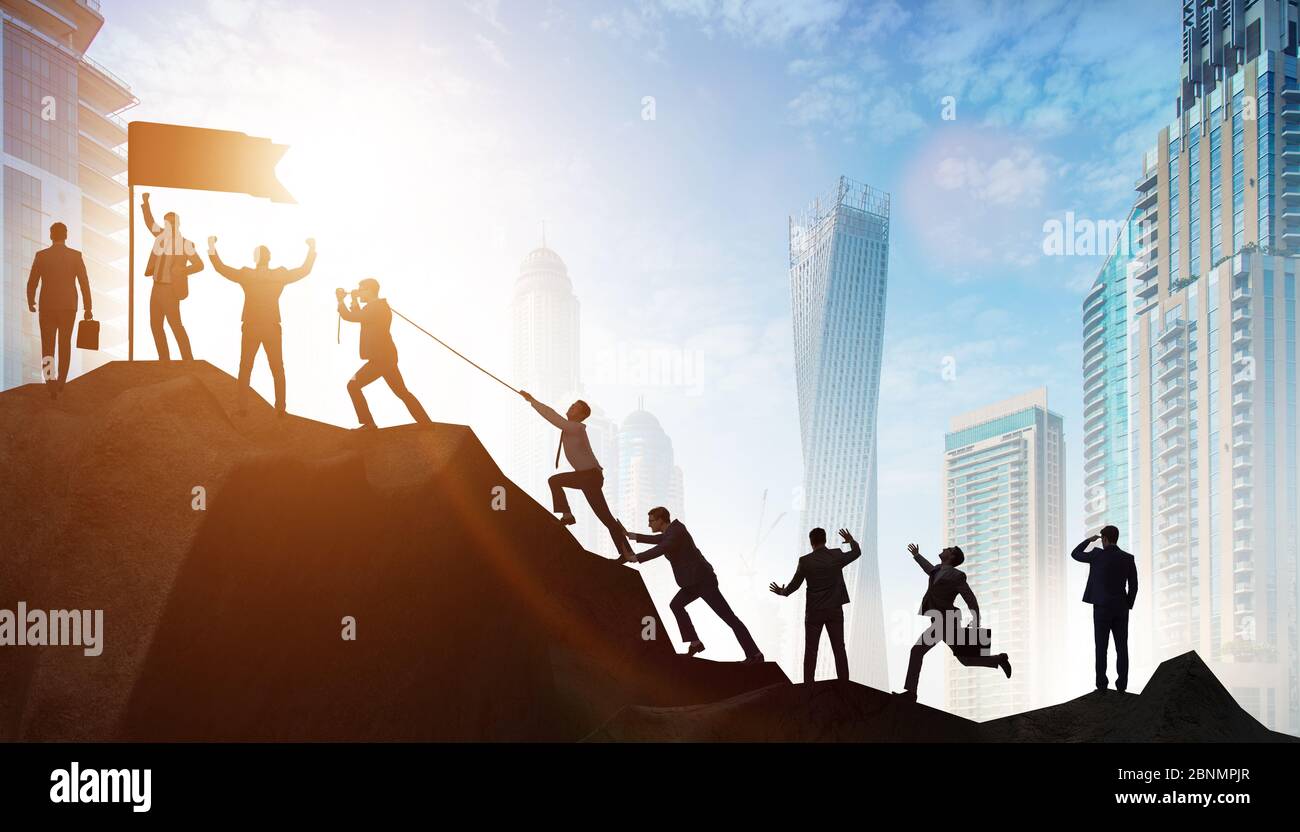 Concept of teamwork with team climbing mountain Stock Photo - Alamy