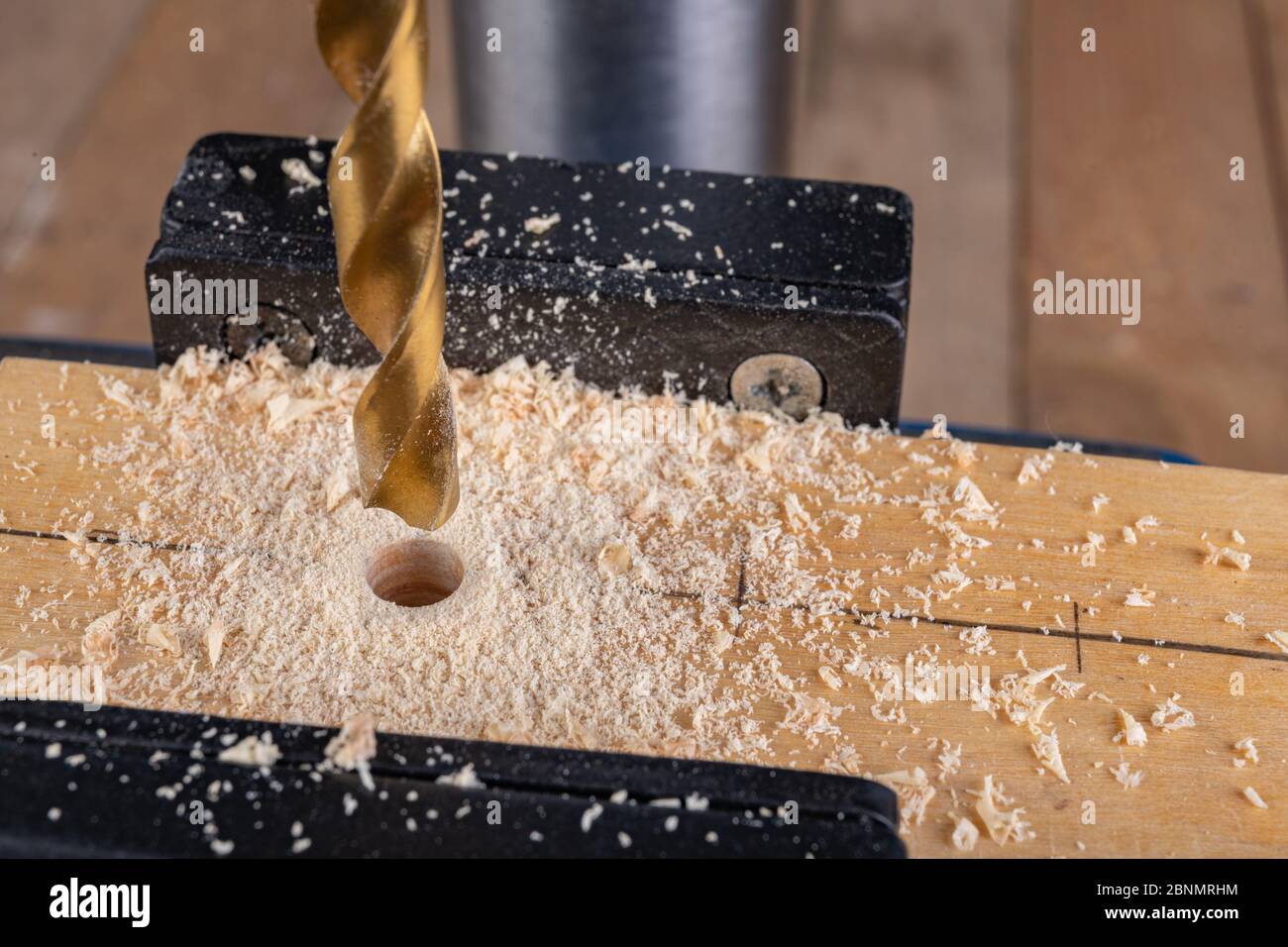 Drilling in wood with professional tools. Work on a bench drill ...