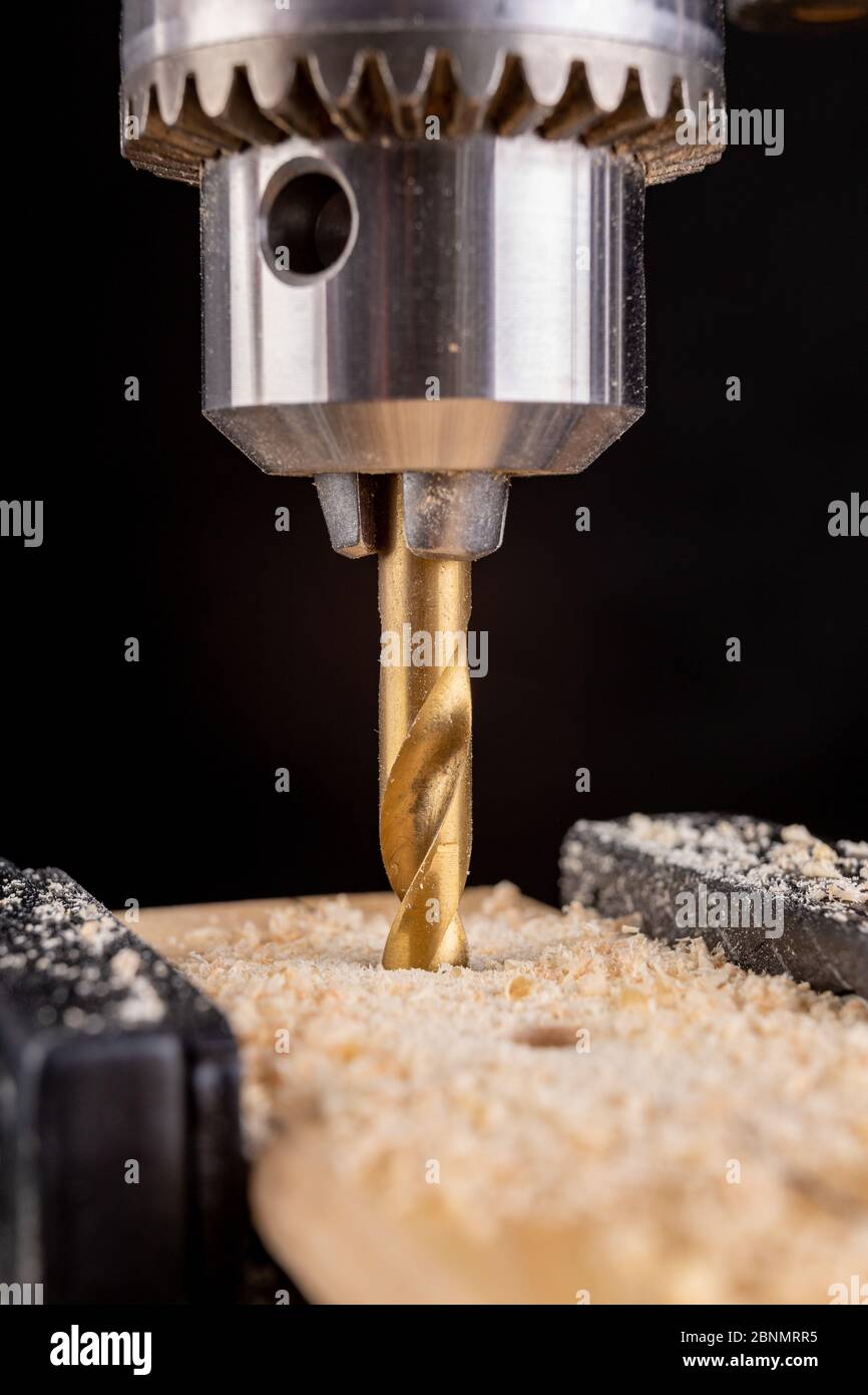 Drilling in wood with professional tools. Work on a bench drill ...