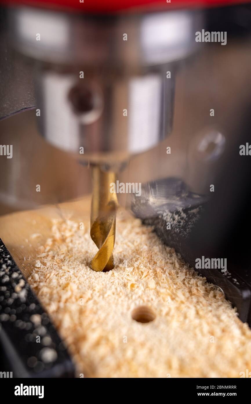 Drilling in wood with professional tools. Work on a bench drill ...