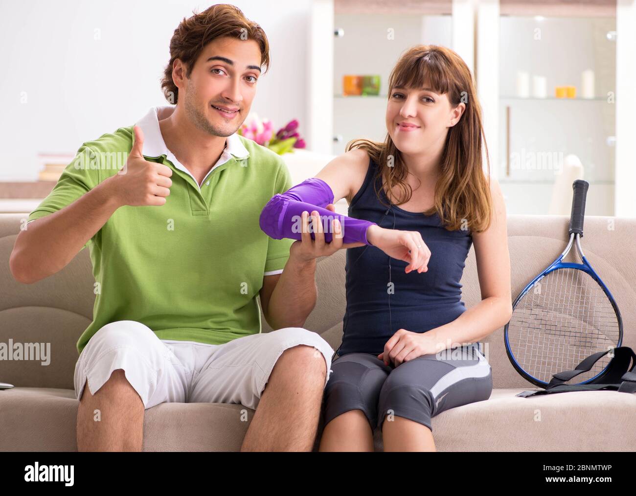 The man and woman discussing elbow strap Stock Photo - Alamy