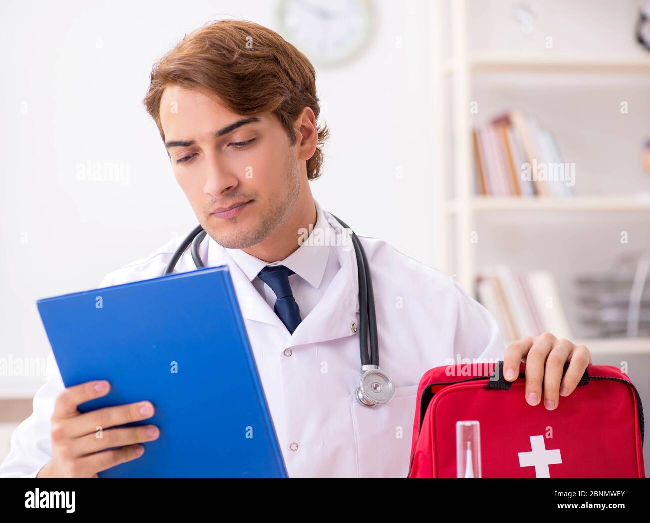 The young doctor with first aid kit in hospital Stock Photo - Alamy