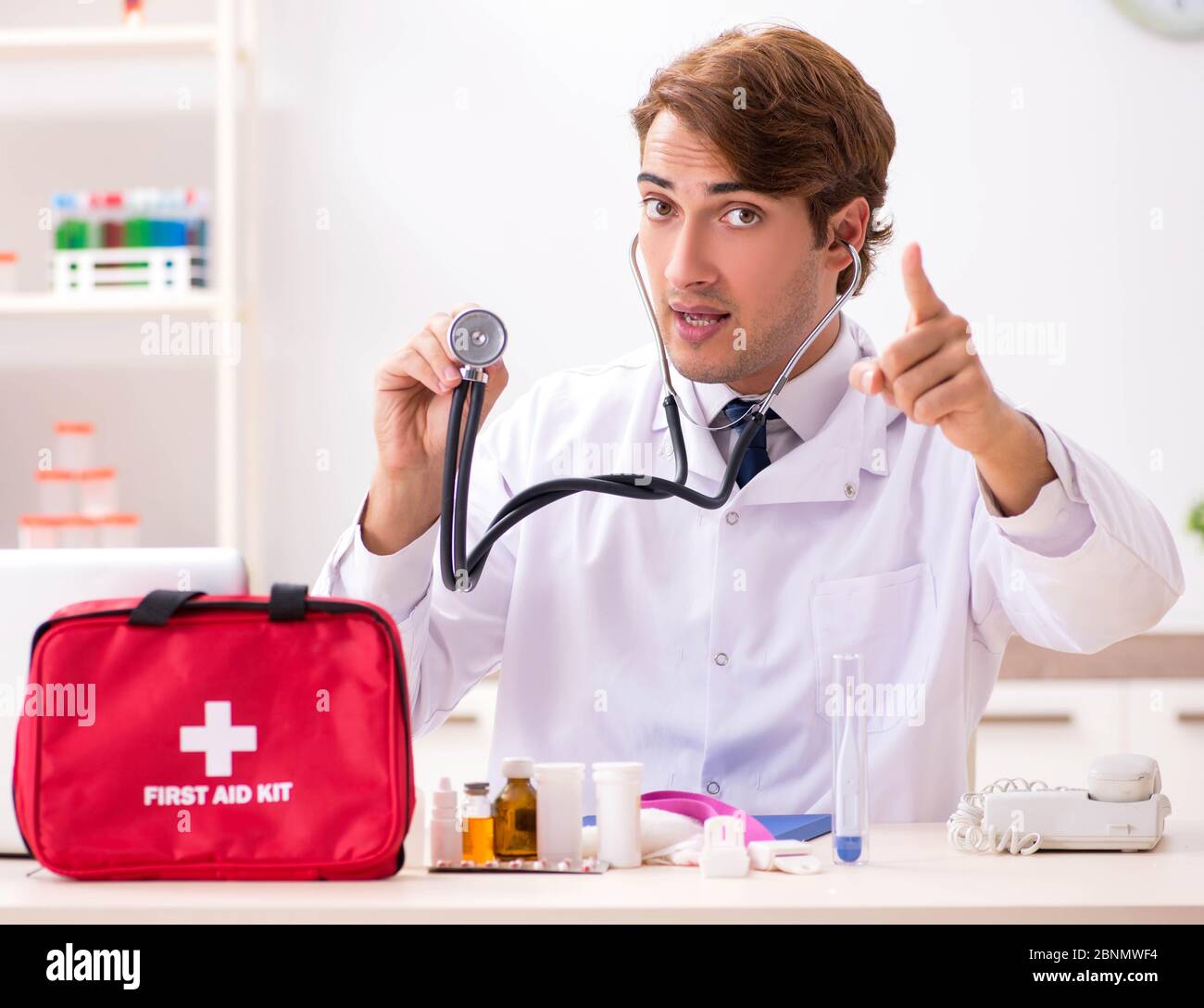 The young doctor with first aid kit in hospital Stock Photo - Alamy
