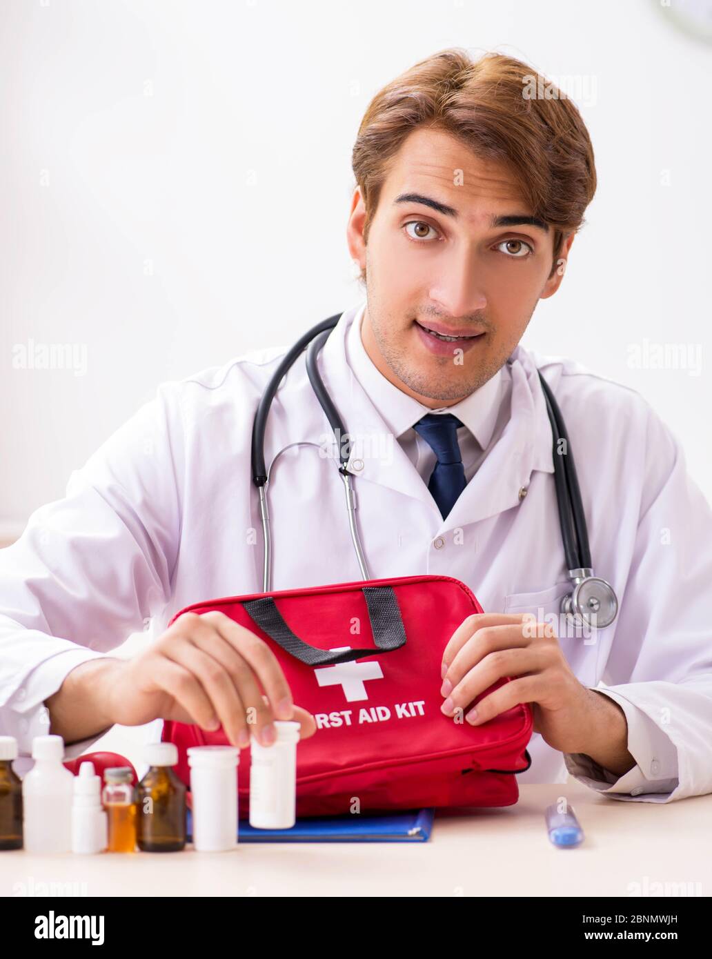 The young doctor with first aid kit in hospital Stock Photo - Alamy