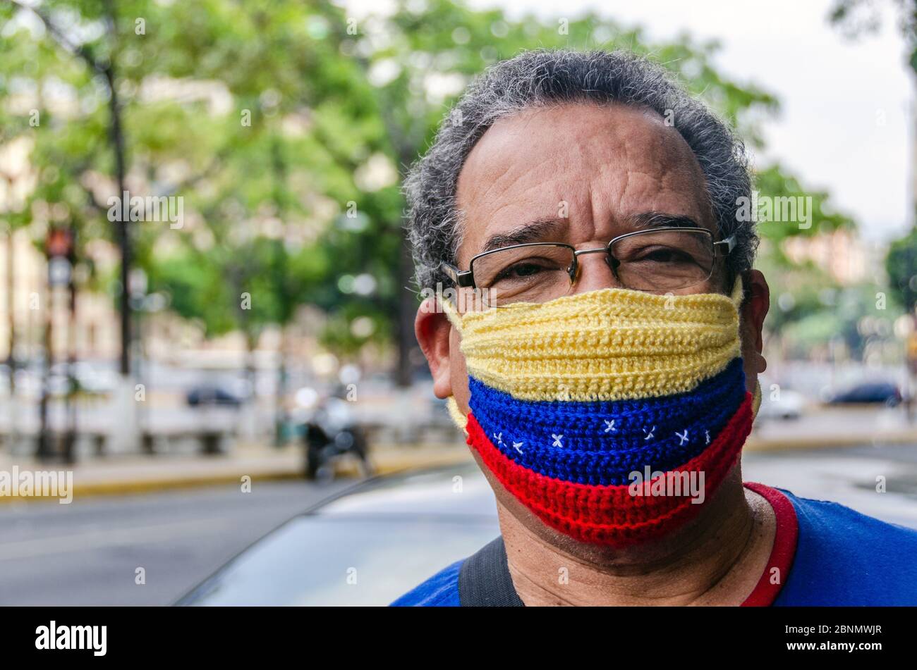 A man wears a mask with the Venezuelan flag, which is mandatory in the ...