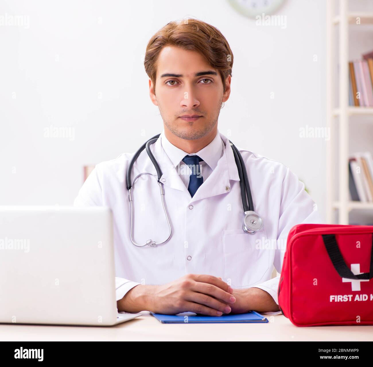 The young doctor with first aid kit in hospital Stock Photo - Alamy