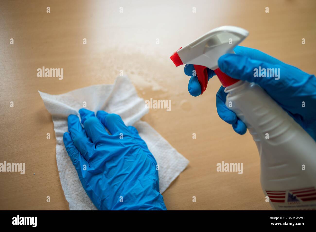 Cleaning home office table sanitizing kitchen table surface with ...