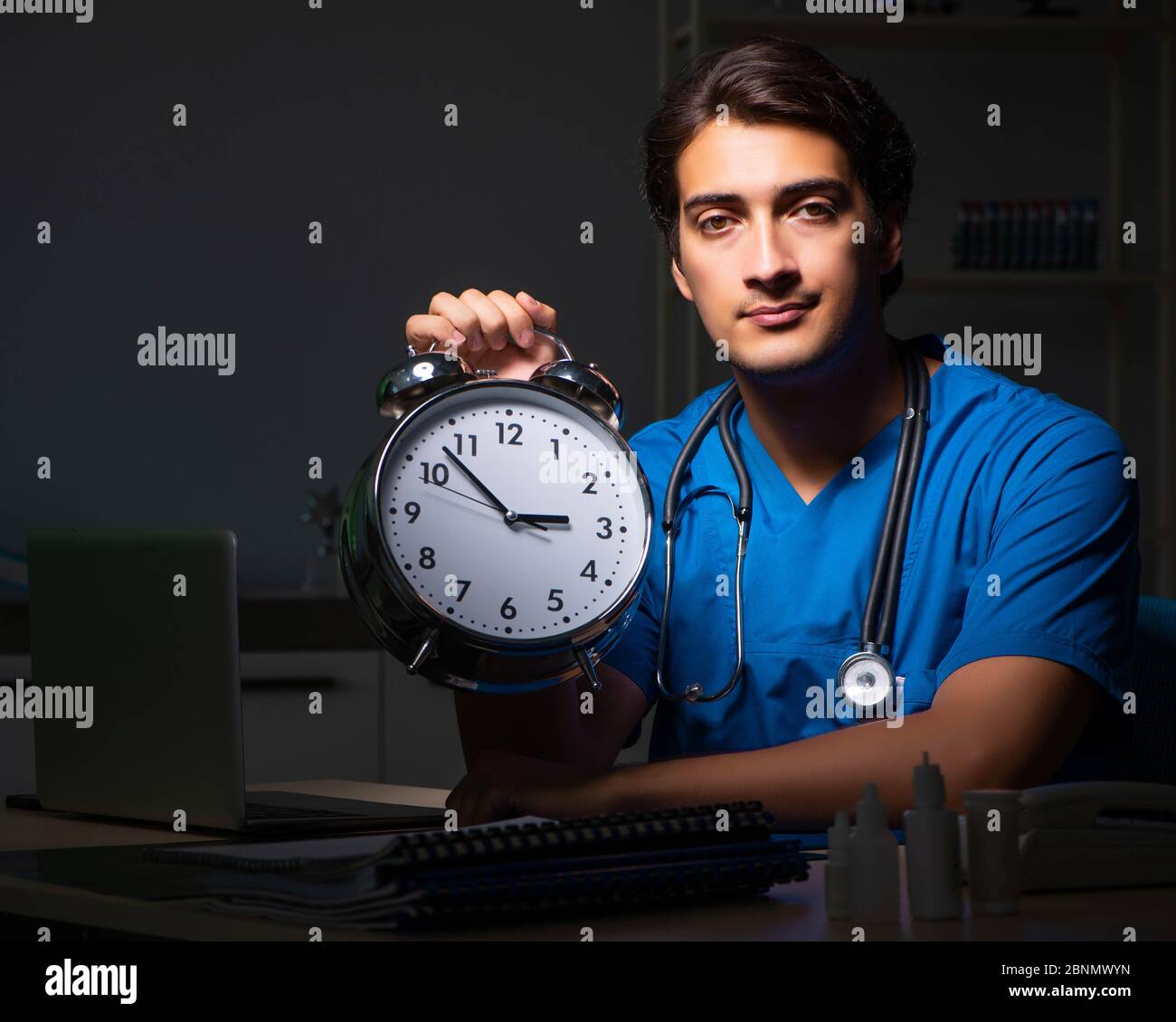 The young handsome doctor working night shift in hospital Stock Photo ...