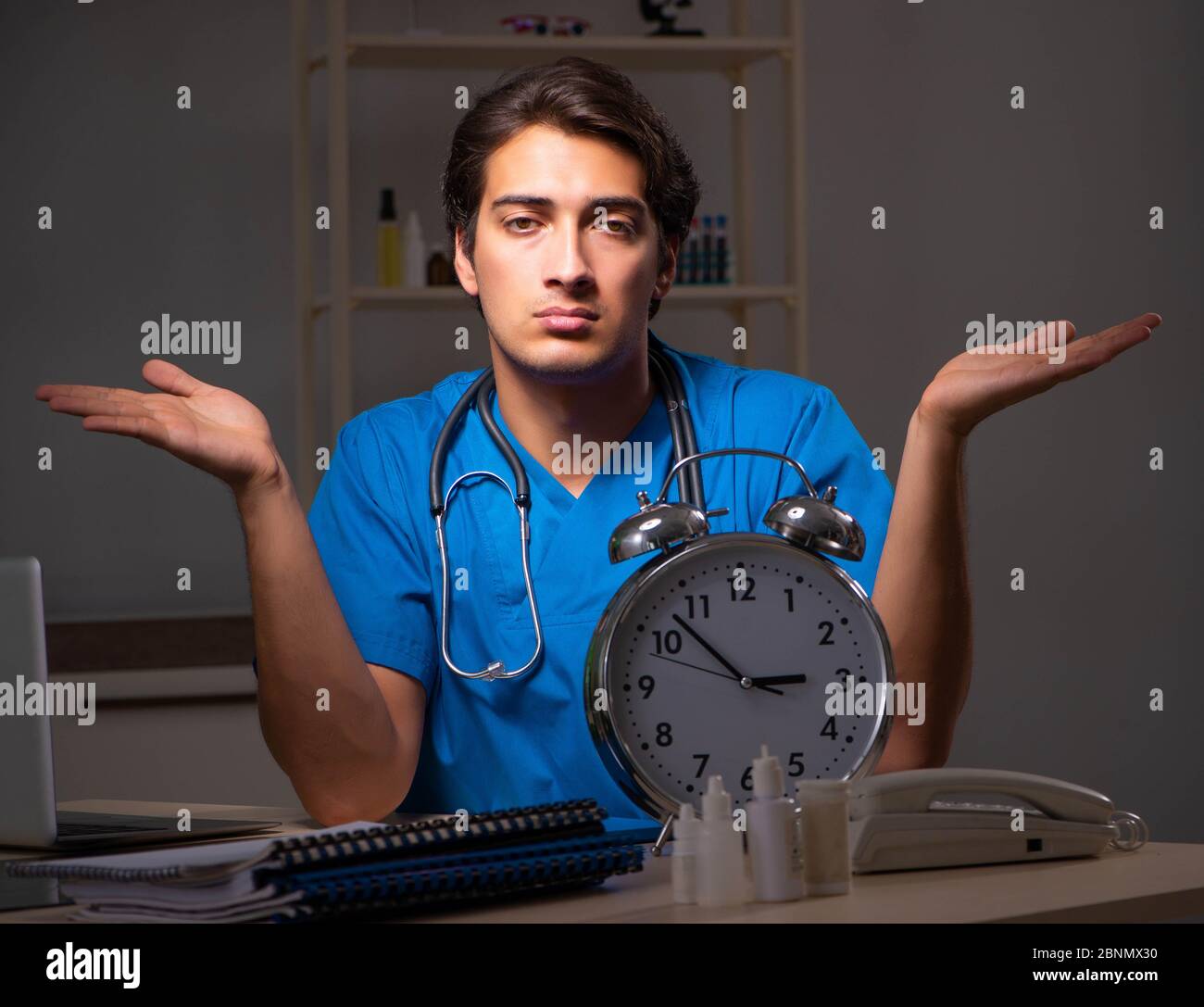 The young handsome doctor working night shift in hospital Stock Photo ...