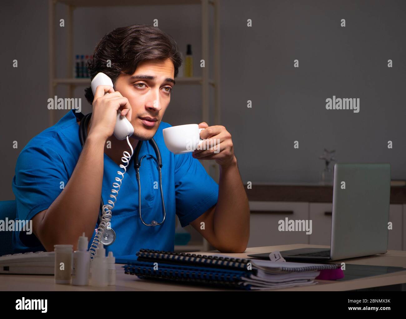 The young handsome doctor working night shift in hospital Stock Photo ...