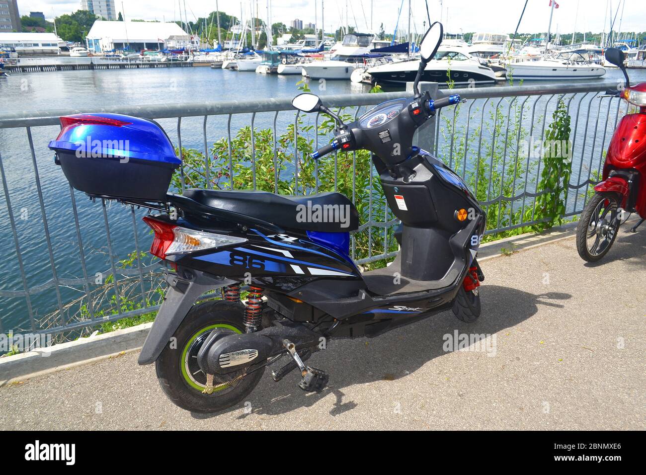 Two motorbikes sitting on the promenade on the harbor of Hamilton with ...
