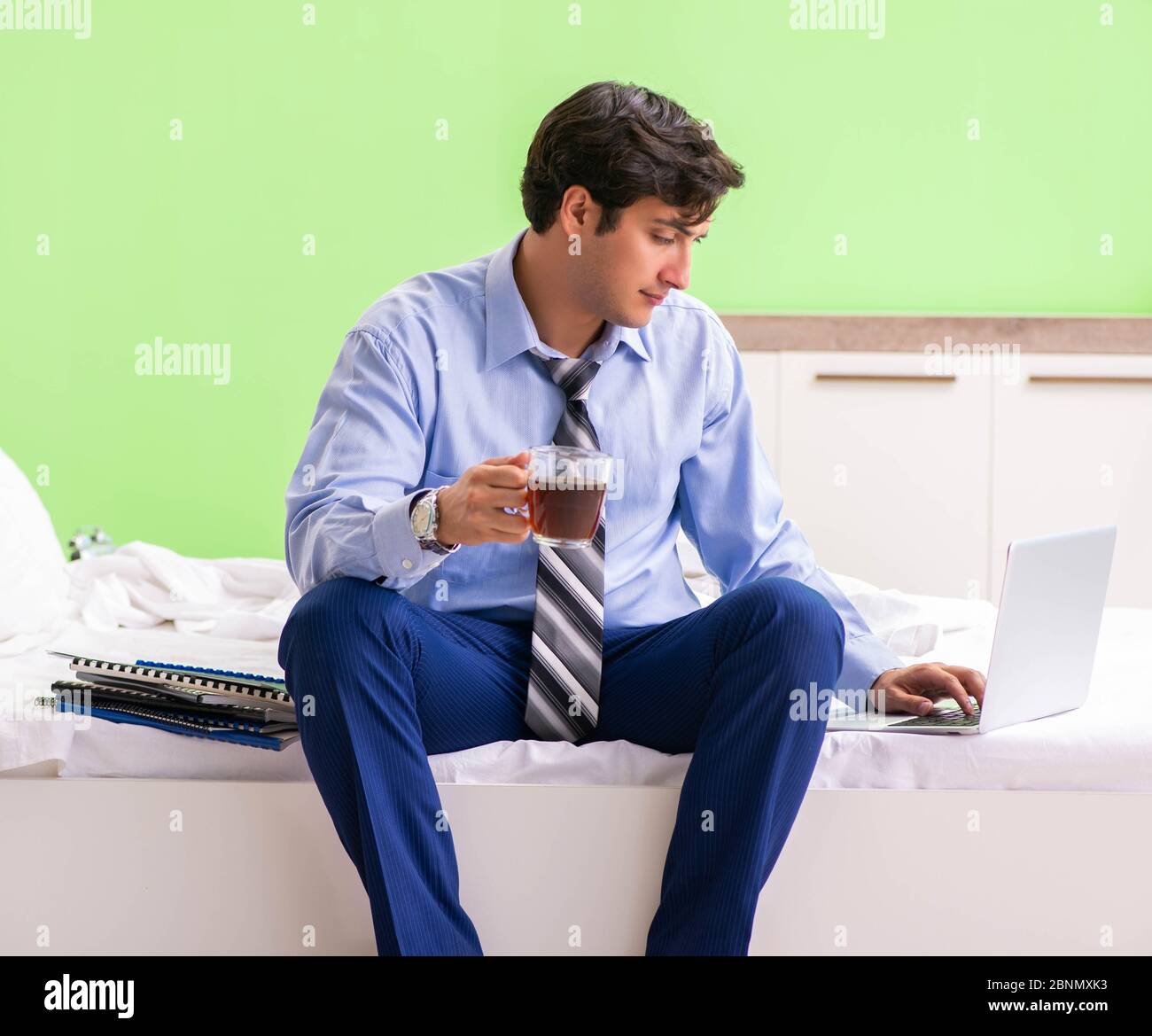 The businessman working overtime in hotel room Stock Photo - Alamy