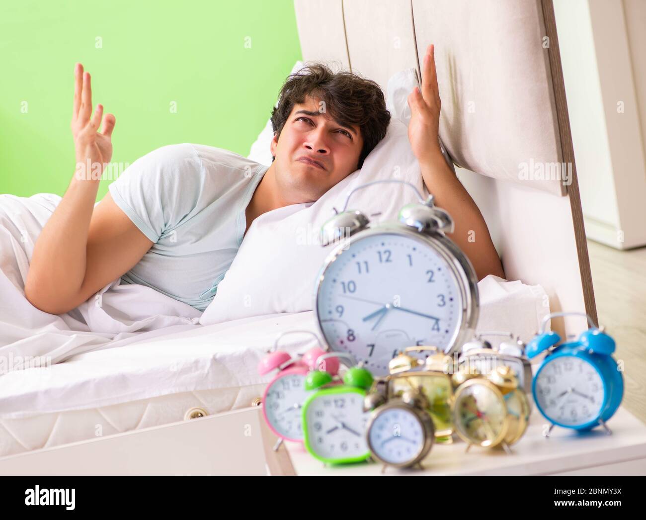 The young man having trouble waking up in early morning Stock Photo - Alamy