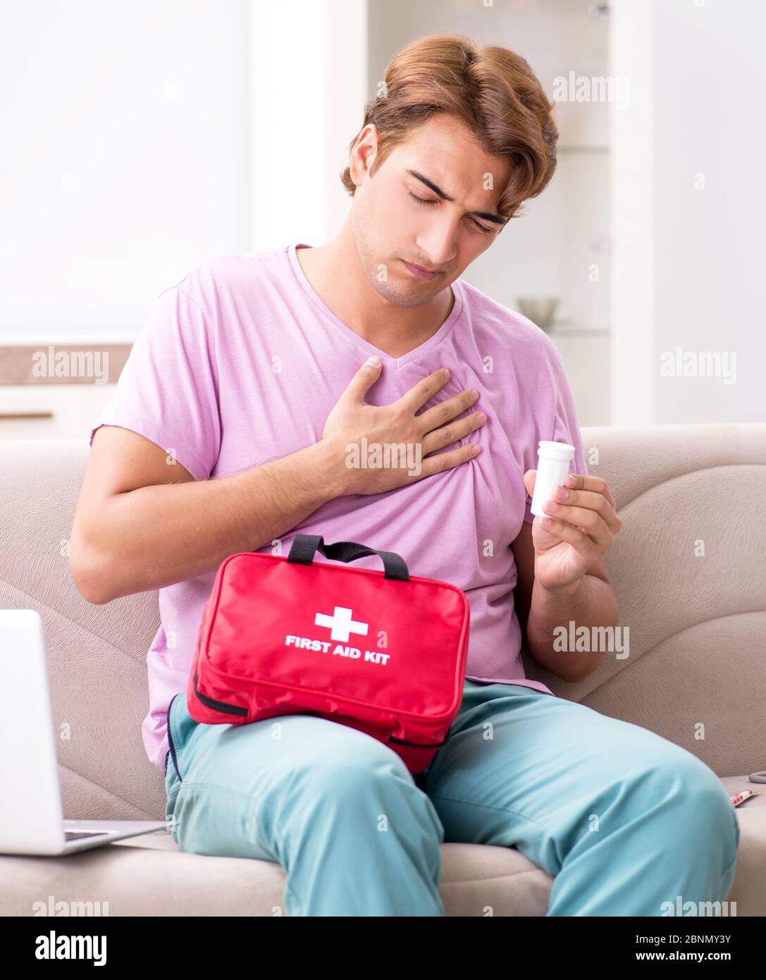 The sick man at home with first aid kit Stock Photo - Alamy