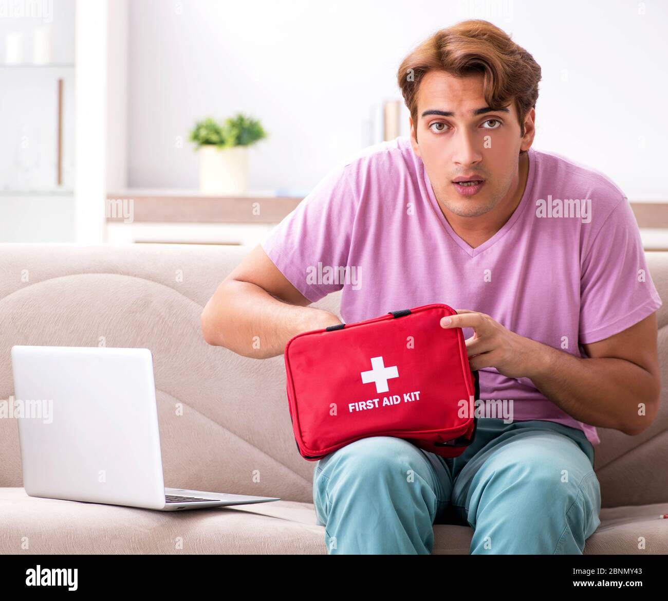 The sick man at home with first aid kit Stock Photo - Alamy