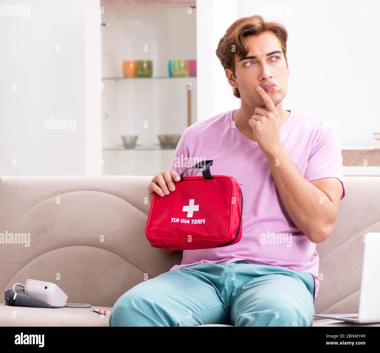 The sick man at home with first aid kit Stock Photo - Alamy