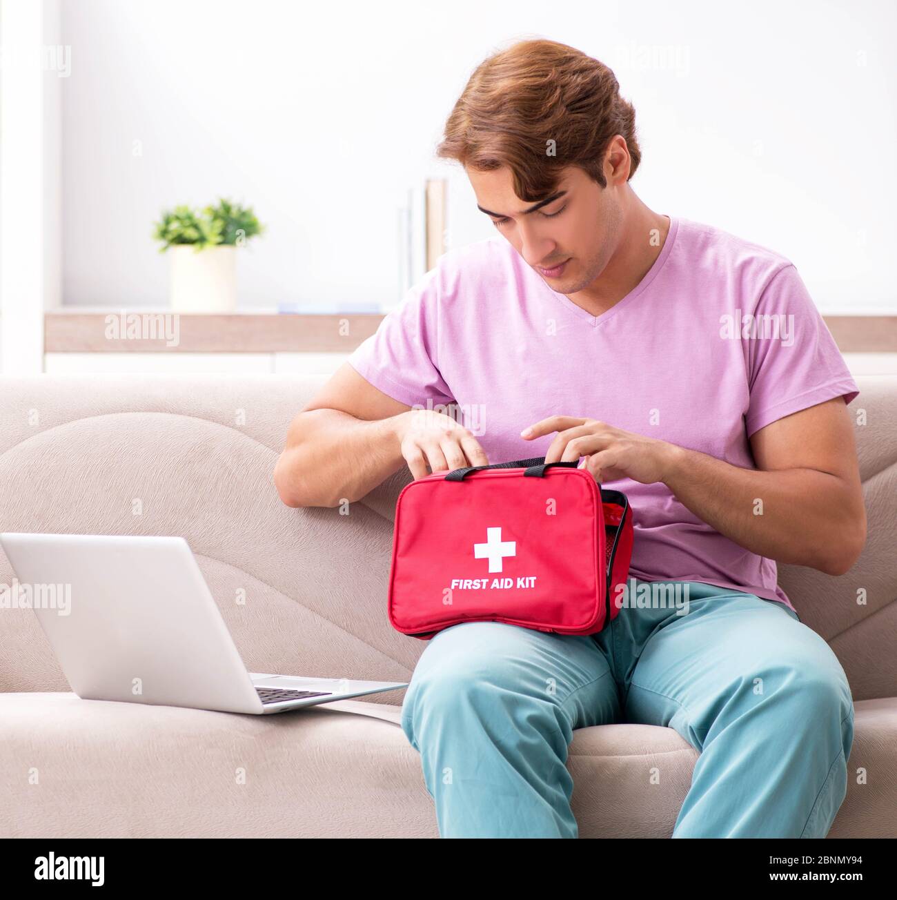 The sick man at home with first aid kit Stock Photo - Alamy