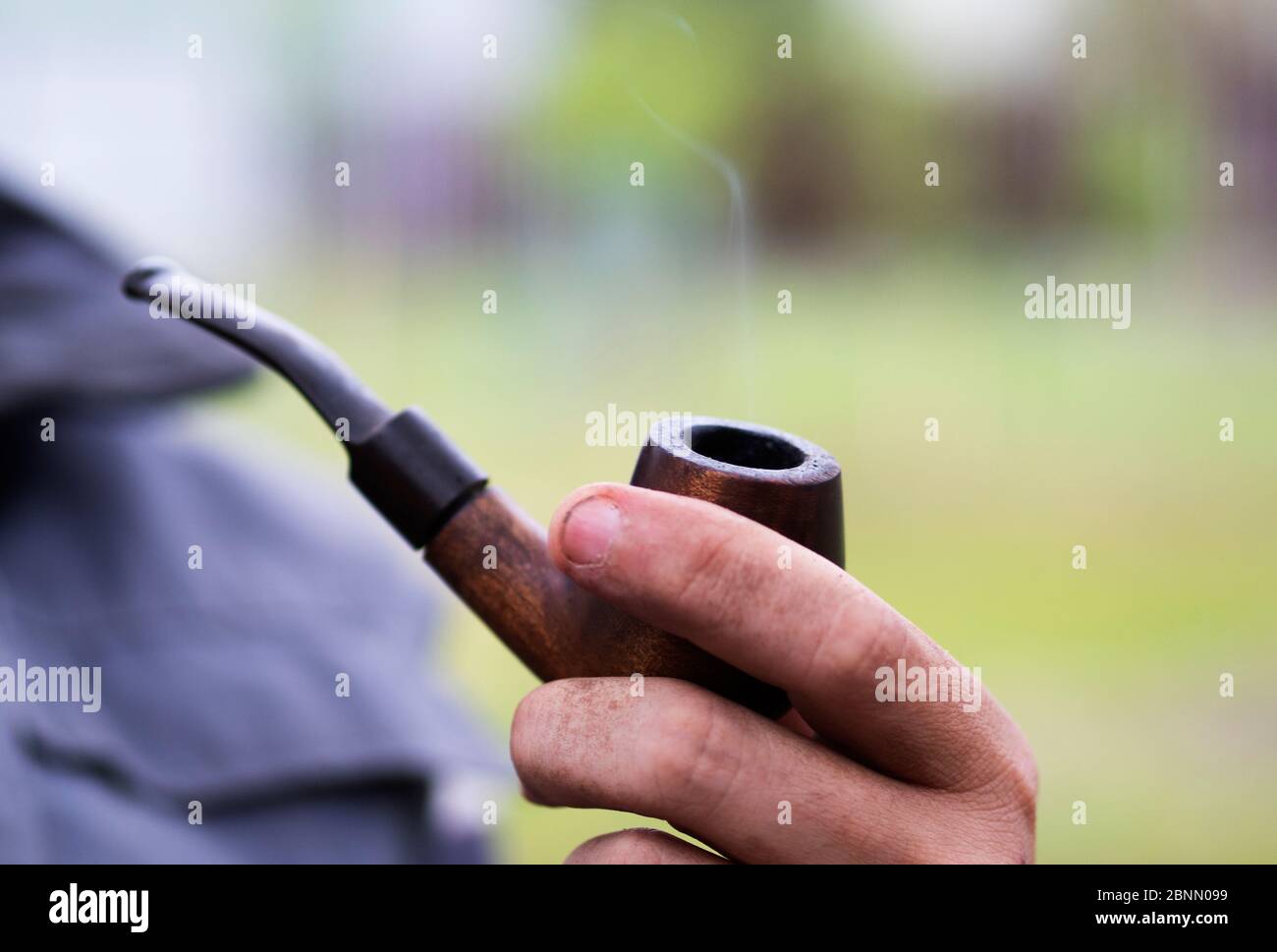 Hand of a Caucasian man with a pipe Stock Photo - Alamy