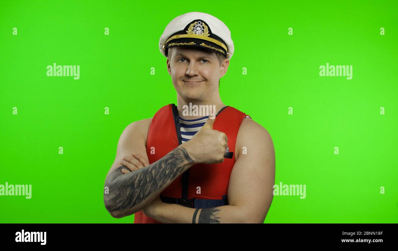 Young muscular sailor man works as lifeguard at beach show thumbs up ...