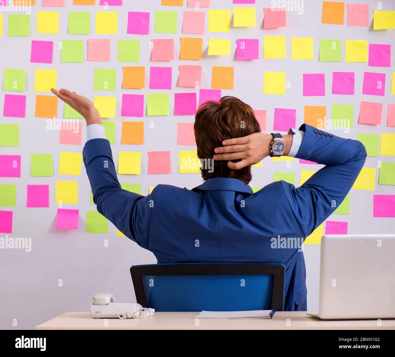 The young handsome man in conflicting priorities concept Stock Photo ...