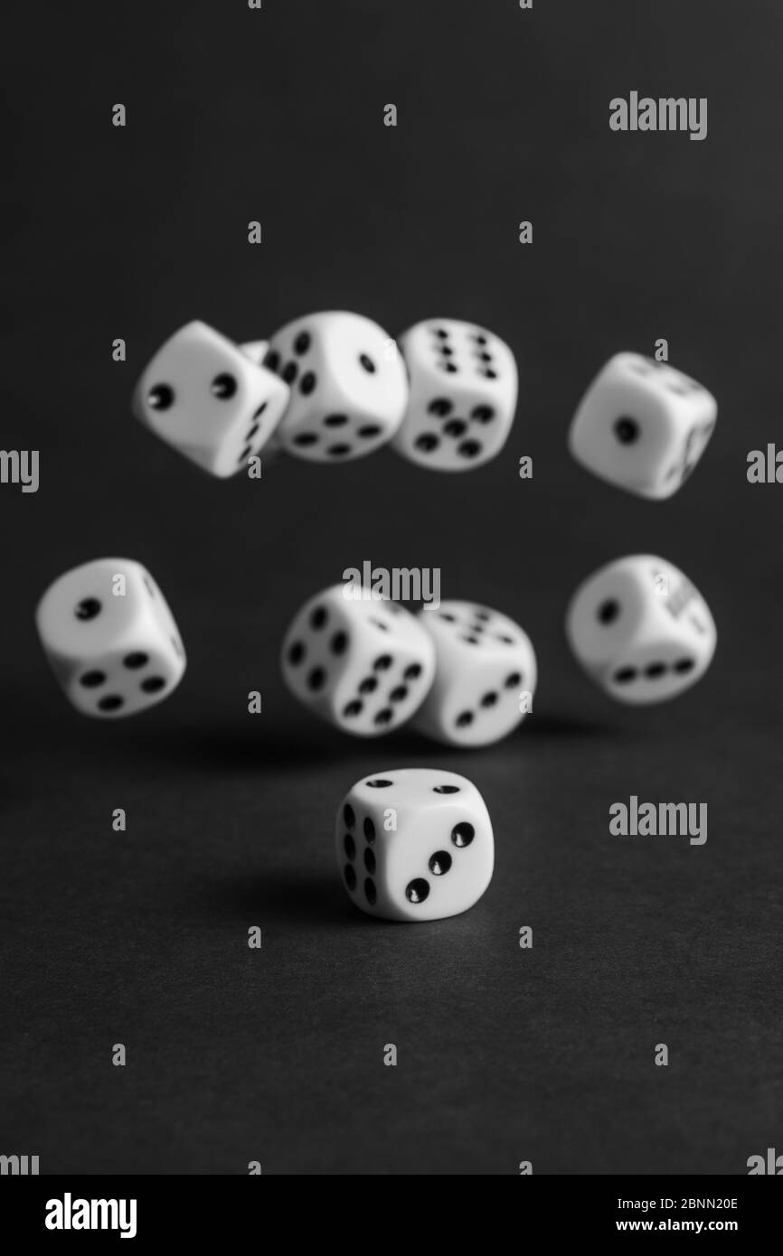 various tumbling dice on a black background in portrait format Stock ...