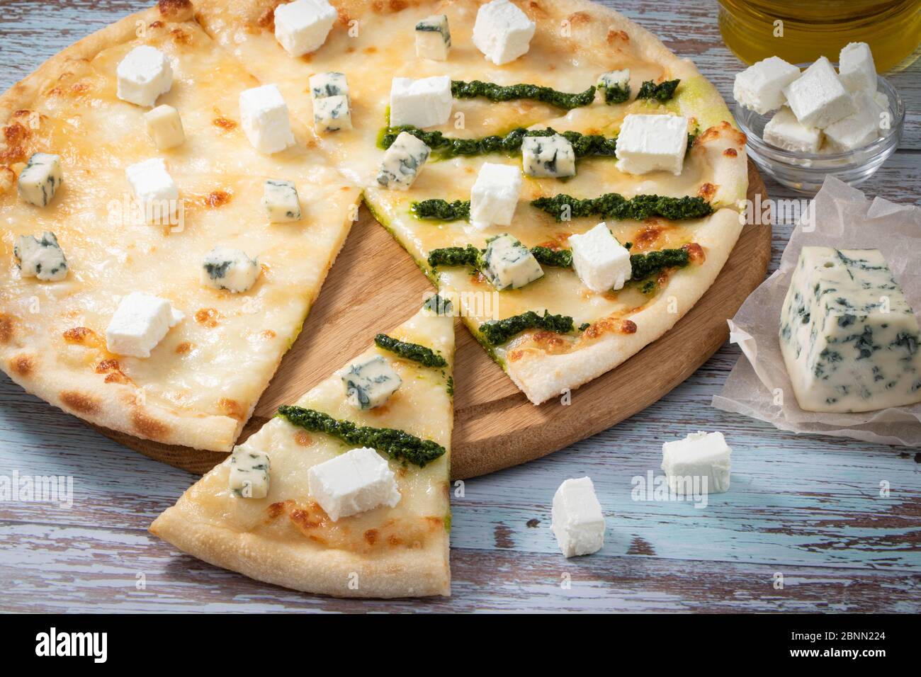 Pizza four cheeses on white wooden table Stock Photo - Alamy