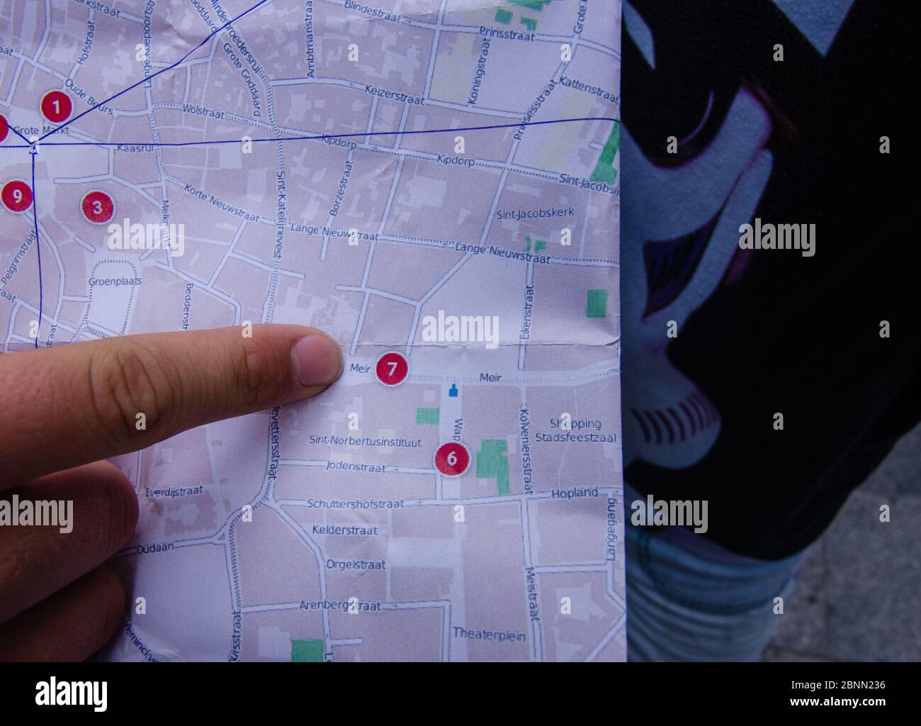 Antwerp, Flanders, Belgium. August 2019. A young tourist points his ...