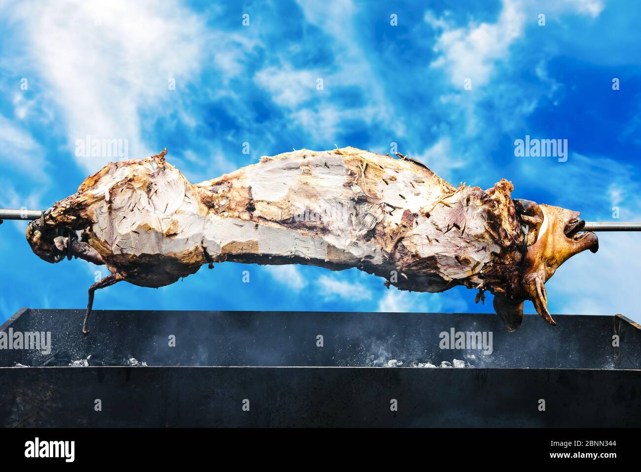 pig on the spit cooked on the grill, barbecue concept Stock Photo - Alamy