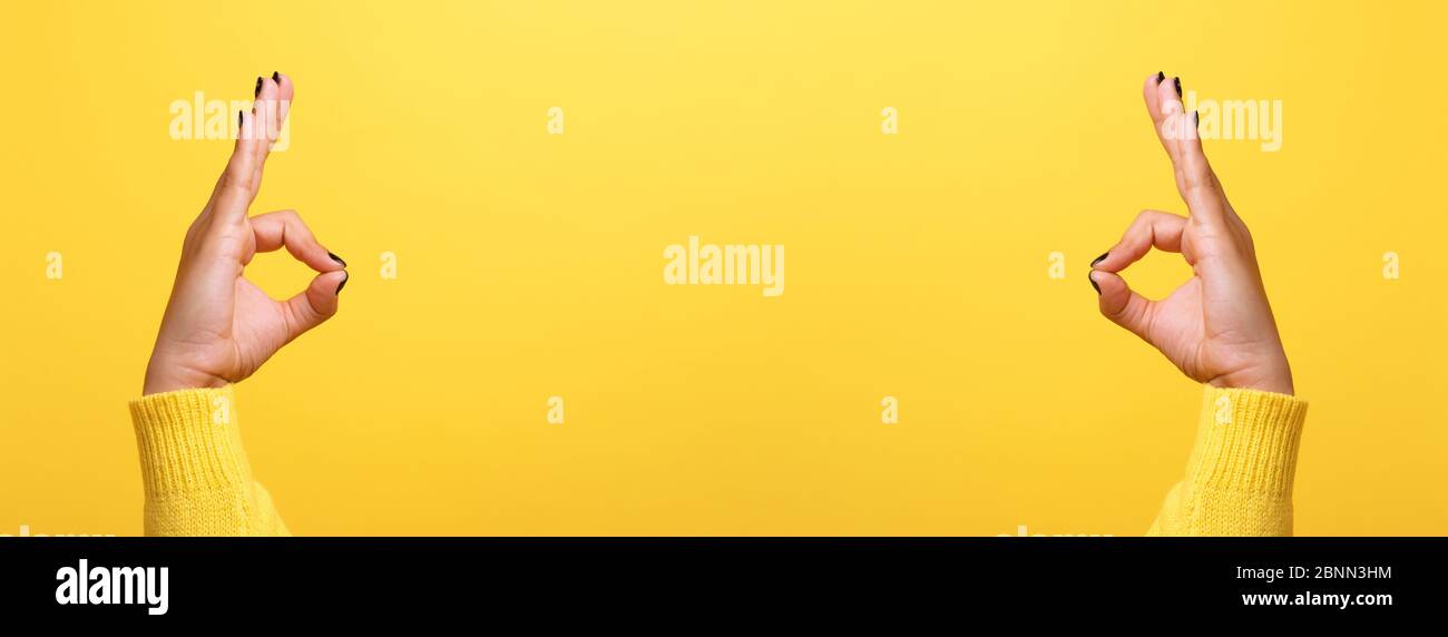 hand ok sign over trend yellow background Stock Photo - Alamy