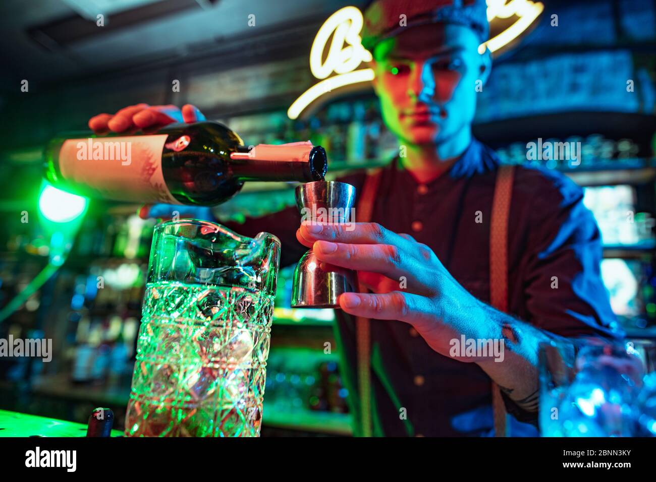 Professional barman finishes preparation of alcoholic cocktail for ...