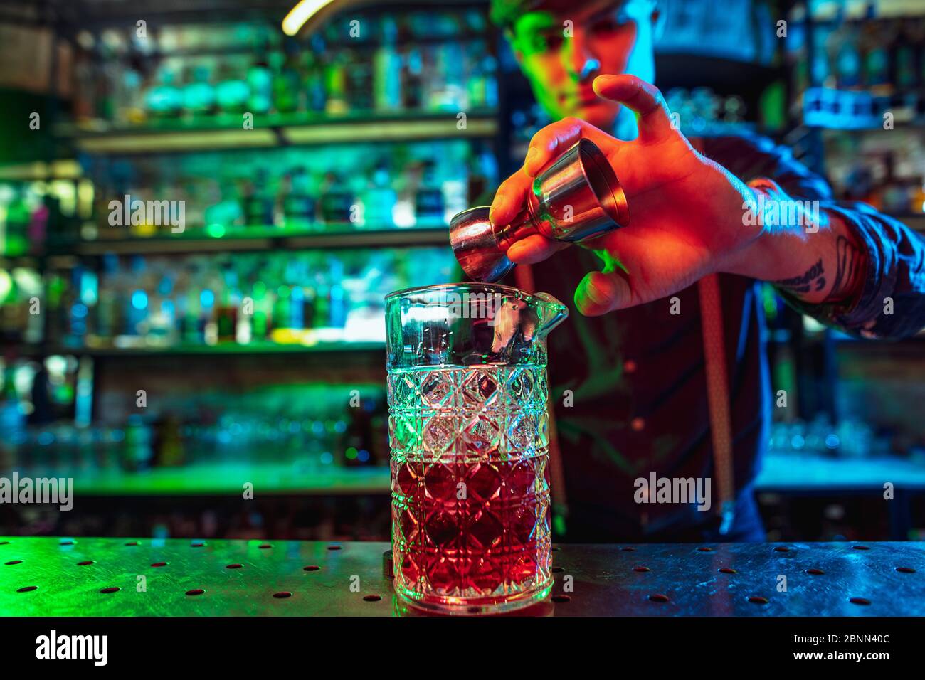 Professional barman finishes preparation of alcoholic cocktail for ...