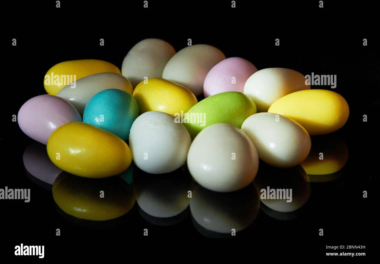 Multi colored candies isolated on black background Stock Photo - Alamy