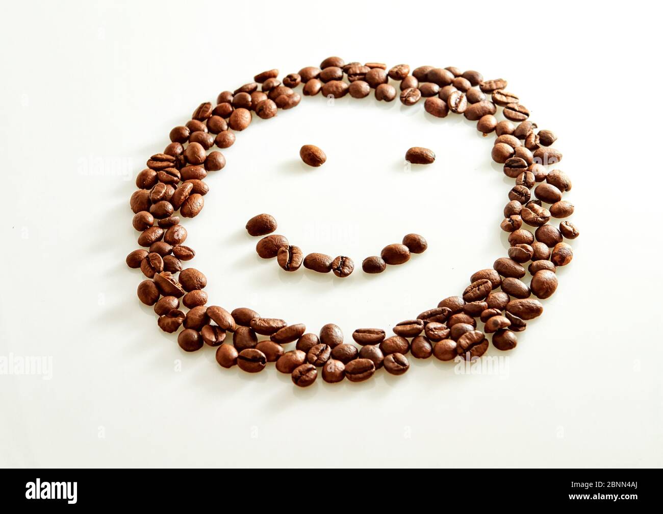 Smile shaped coffee beans isolated on white background Stock Photo - Alamy