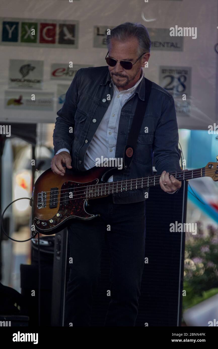 Bass player, in band, playing at outdoor concert Stock Photo - Alamy