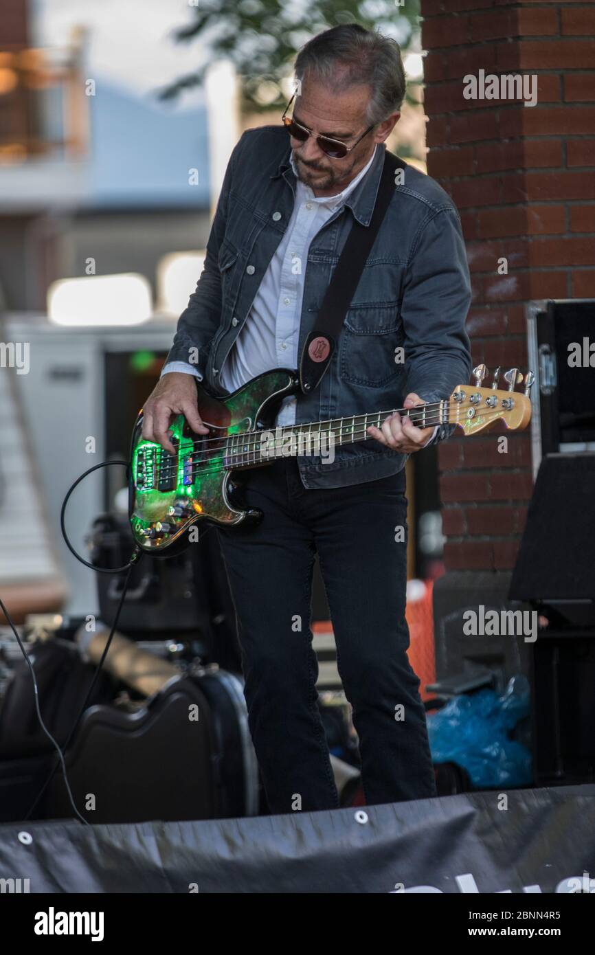 Bass player, in band, playing at outdoor concert Stock Photo - Alamy
