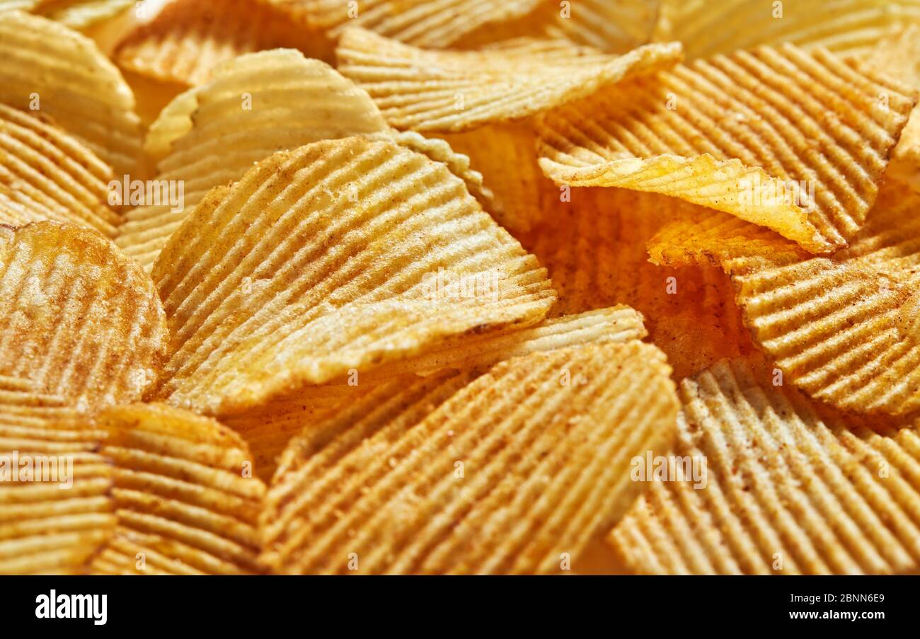 Slices Golden chips with stripes lying slides background texture. Side ...