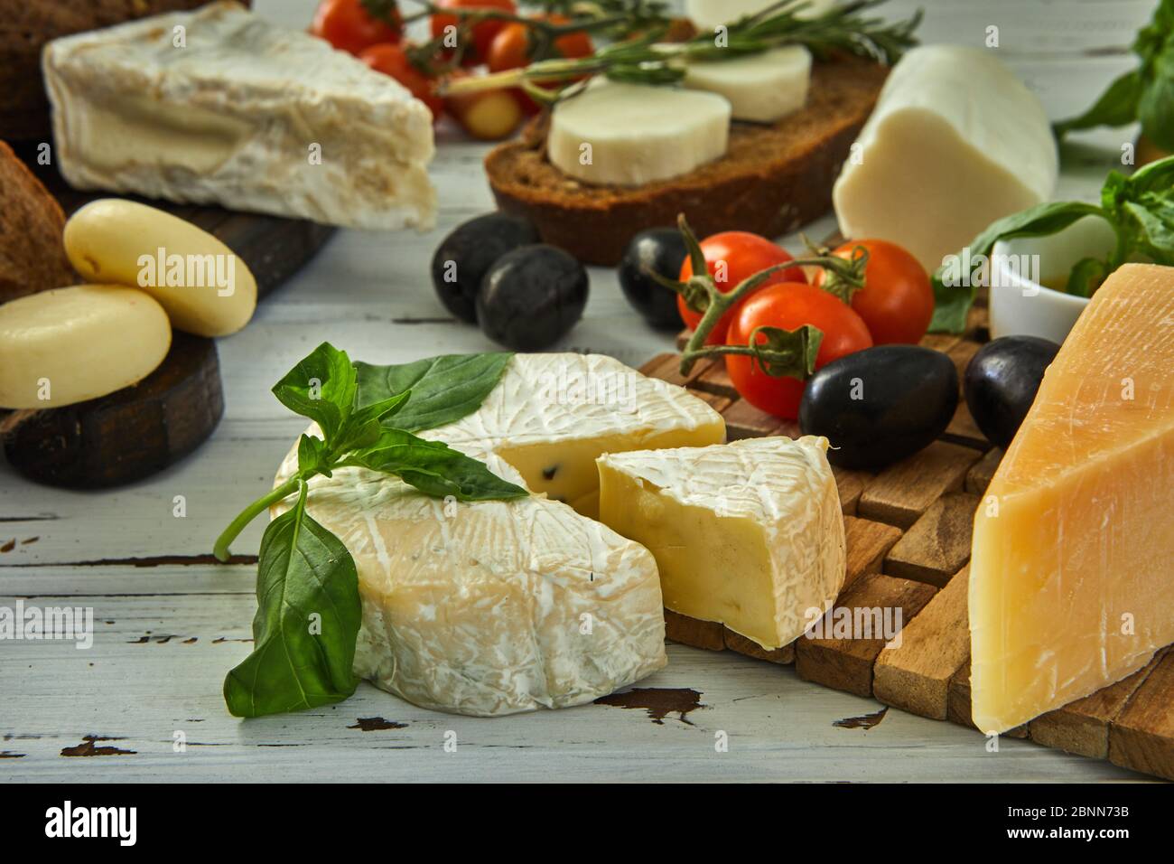 Different cheeses on table. Fresh dairy products. Cheese selection on a ...