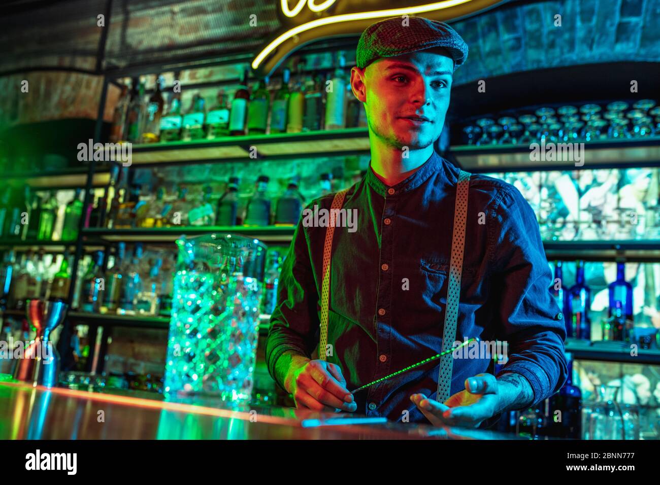 Professional barman proposing alcoholic cocktails, shots, beverages to ...