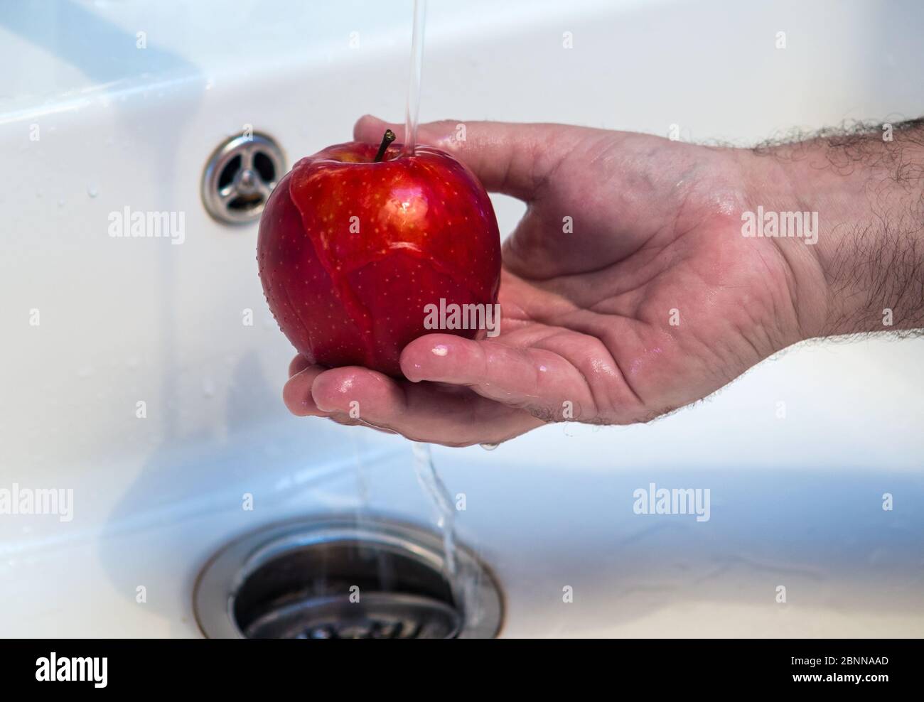 Red apple with a tap hi-res stock photography and images - Alamy