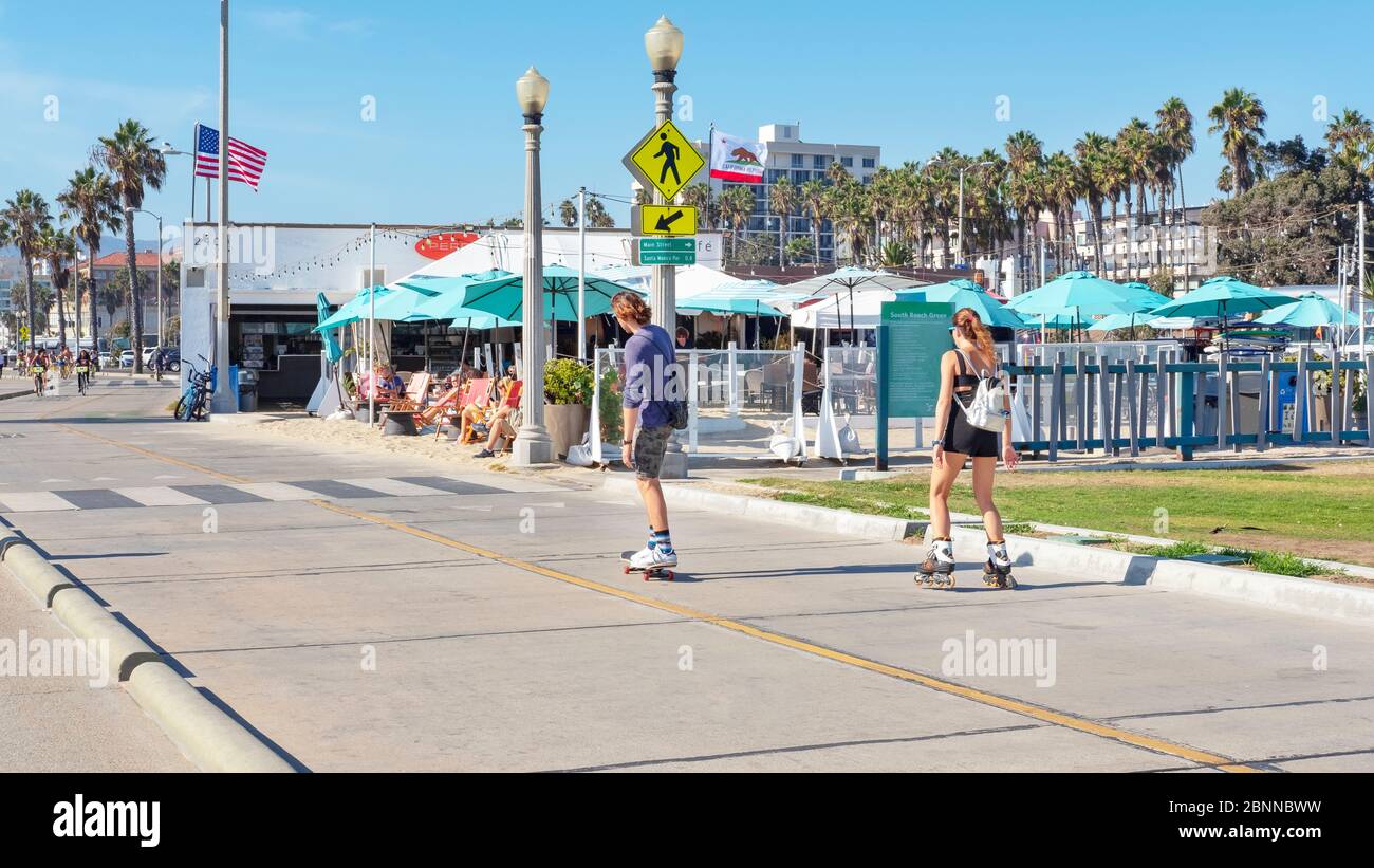 Young people, tourists or locals, on skateboard and roller skates ...
