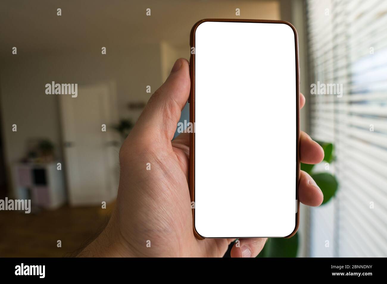 Working on mobile. Taking a picture. Phone in hand with white screen ...