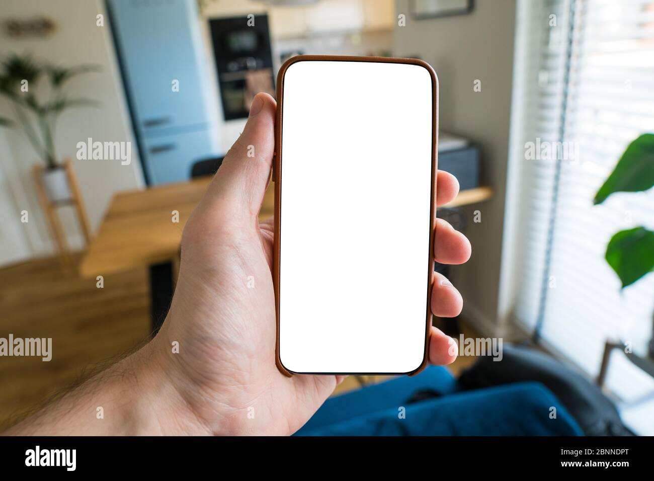 Working on mobile. Taking a picture. Phone in hand with white screen ...