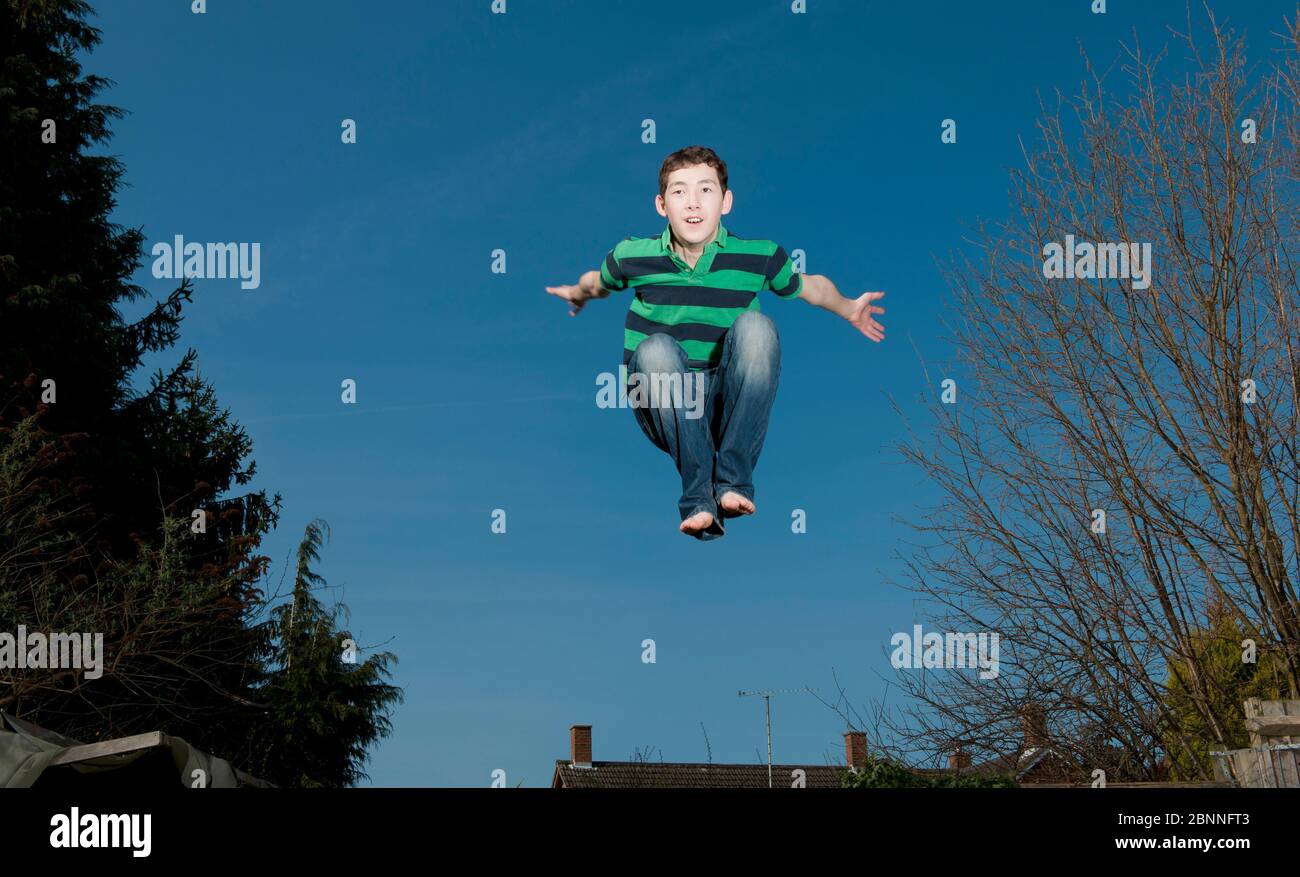 boy jumping on trampoline in Woking - England Stock Photo - Alamy