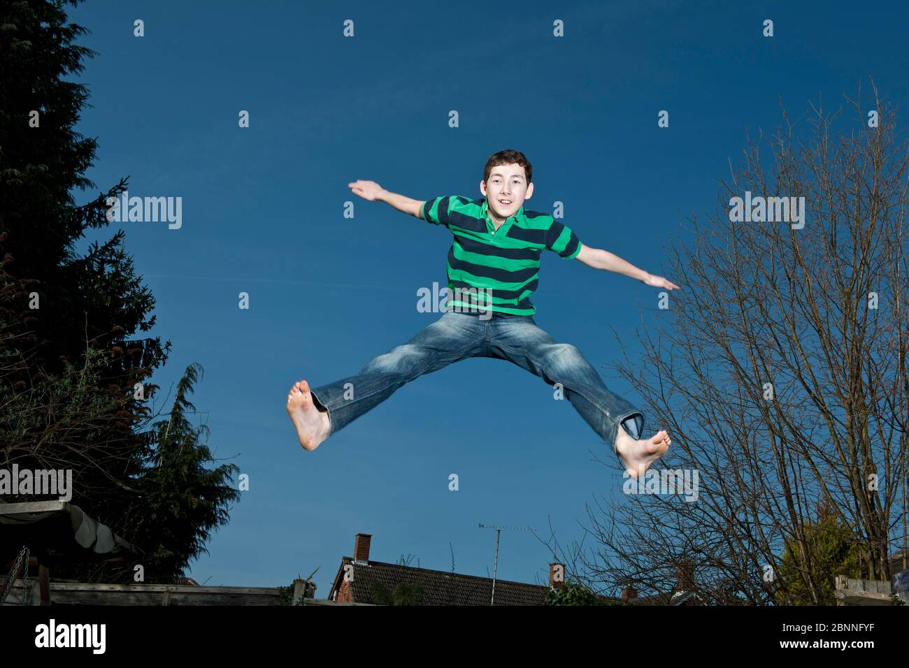 boy jumping on trampoline in Woking - England Stock Photo - Alamy