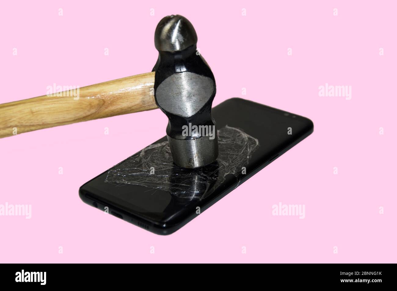 Hammer destroying the screen of a mobile phone Stock Photo - Alamy