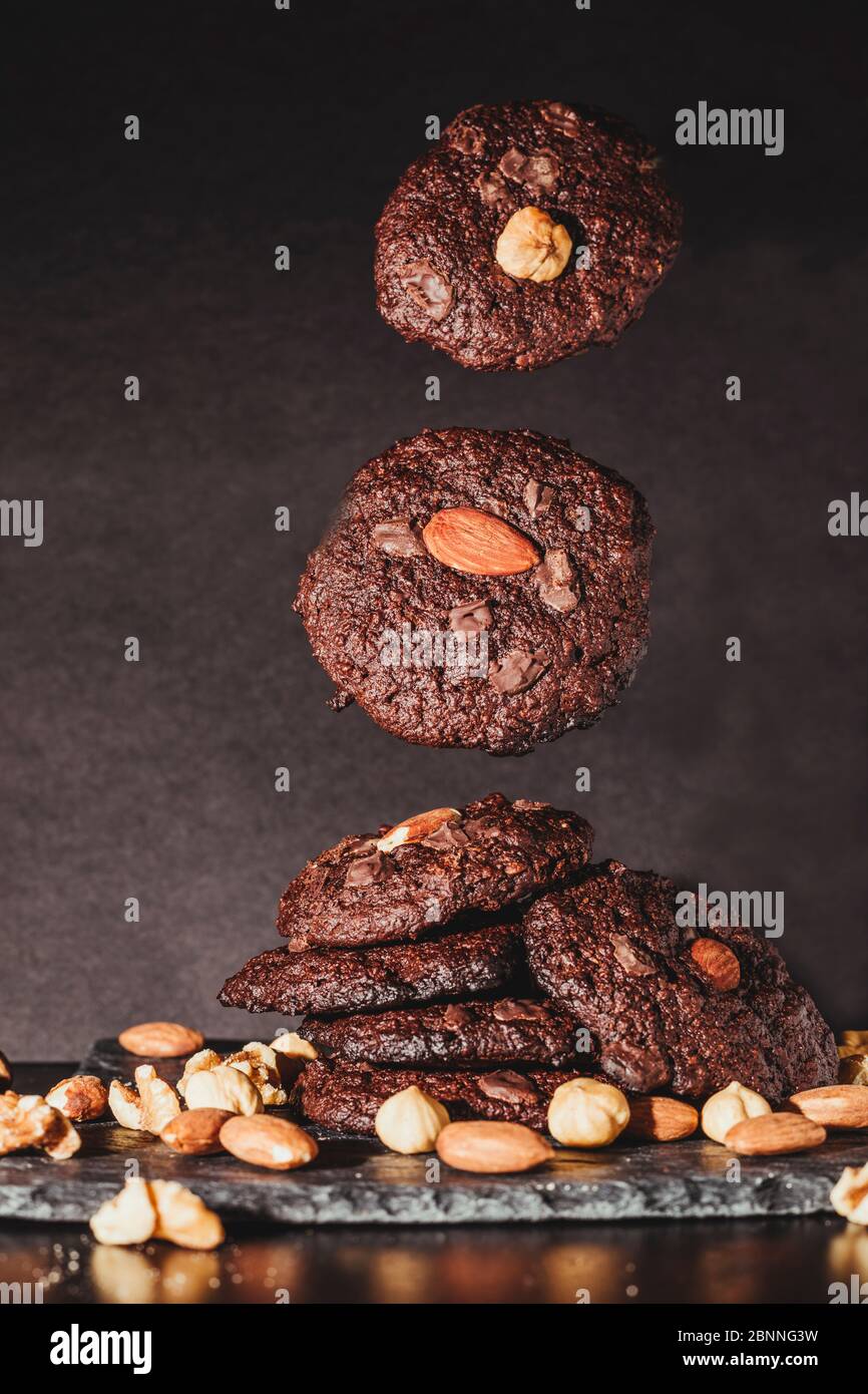 Delicious homemade chocolate chip cookies with nuts falling down Stock ...