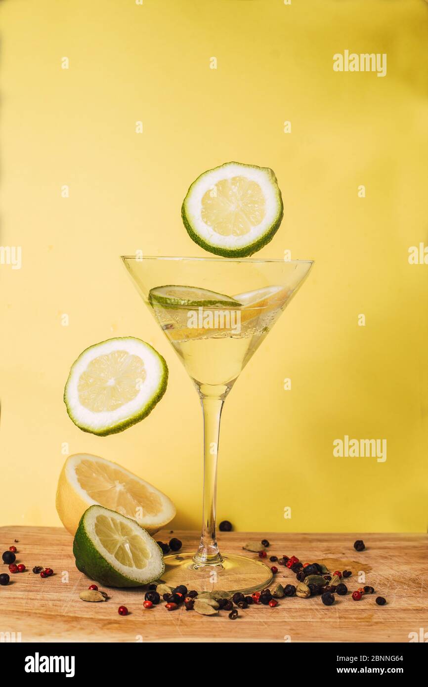 Levitating slices of lemon and lime, on a yellow background Stock Photo ...